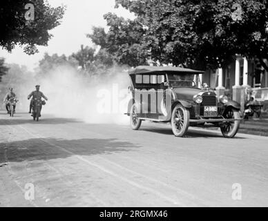 Police on motorcycle trailing car with smoke ca. 1923 Stock Photo - Alamy
