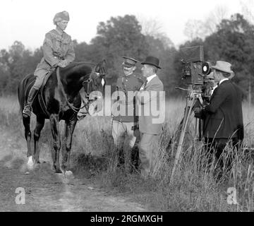 Director D.W. Griffith on location filming a movie, speaking with ...