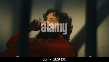 A prisoner smoking a cigarette in his prison cell Stock Photo - Alamy