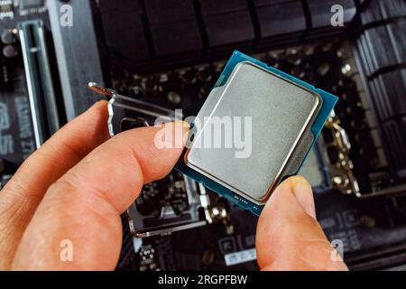 Hand of computer engineering plugging computer cpu processor memory change components into ...