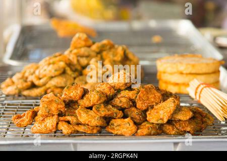 Fried fish starters at a street food stall in the city of Bangkok in ...