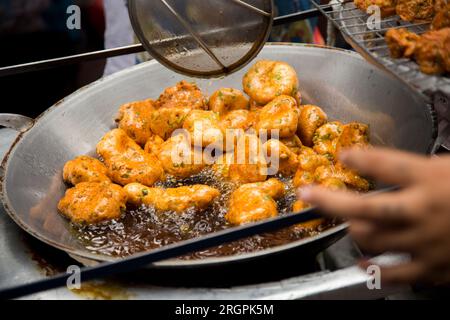 Fried fish starters at a street food stall in the city of Bangkok in ...