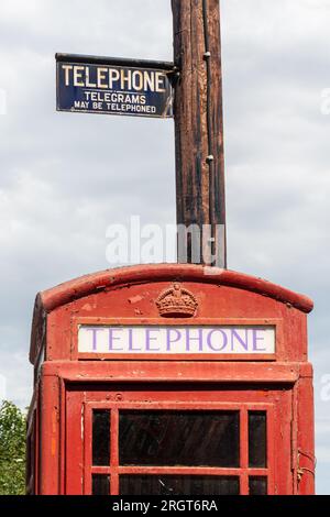 Red phone box in Longstock village with historic old sign reading ...
