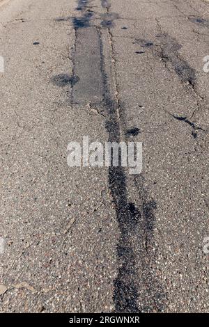 repair of a broken and damaged paved road, the road has many defects ...