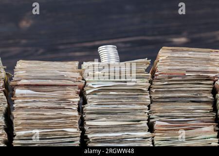 a large amount of old crumpled and dirty money, stacked in huge piles ...