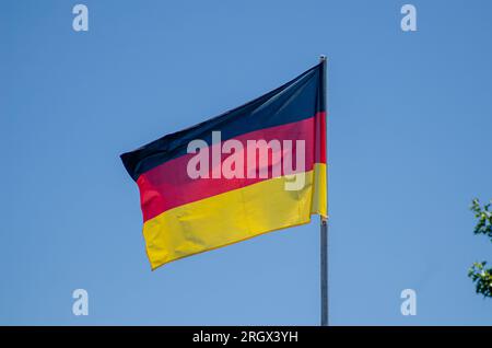 The flag of Germany tricolour flying at wind Stock Photo - Alamy