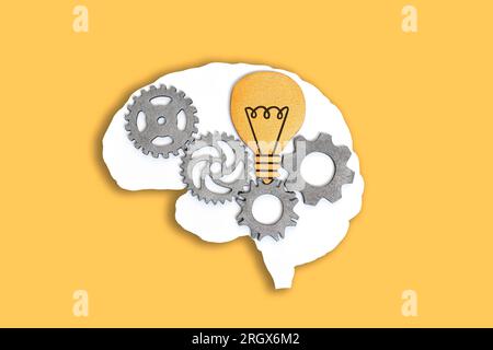 Human brain outline with wooden cogs and lightbulb isolated on black ...