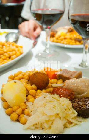Traditional Spanish cocido madrileño in bowl isolated on white ...