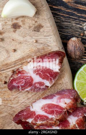 pork and bacon sliced during cooking, dried meat cut into pieces on a ...