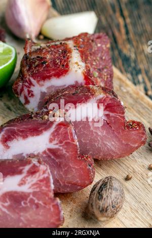 pork and bacon sliced during cooking, dried meat cut into pieces on a ...