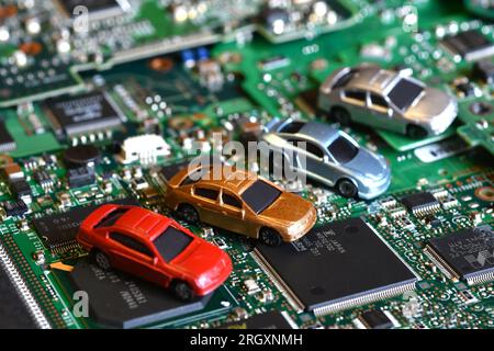Toy cars on electronic board and microchip. Conceptual image for ...