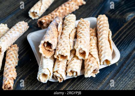 thin crispy waffles lie on a black table, sweet food for desserts Stock ...