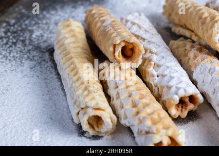 thin crispy waffles lie on a black table, sweet food for desserts Stock ...