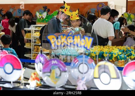 Yokohama, Japan. 13th Aug, 2023. A girl hugs an inflatable Pikachu at Minatomirai in Yokohama ...