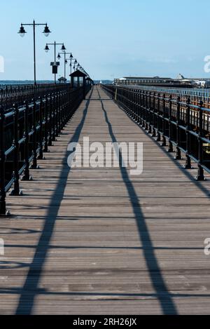 Pedestrian walkway along Ryde pier on the Isle of Wight looking back to ...
