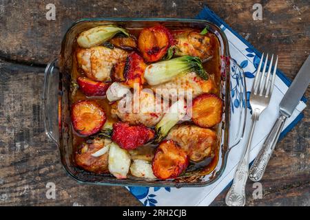 Chicken drumsticks with plums and pak choi Stock Photo - Alamy
