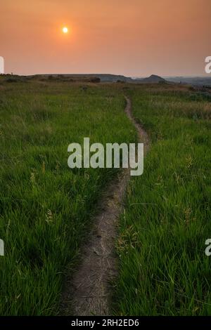 Hazy summer sunset muted by wildfire smoke over Theodore Roosevelt ...