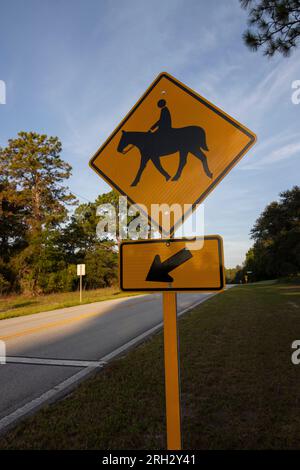 Horse crossing warning sign at the side of a road Stock Photo - Alamy