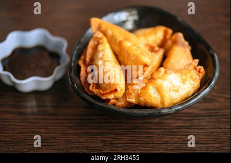 Plate with tasty Japanese gyoza and sauce on color background Stock ...
