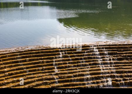 Stone Block Dam On A Lake Stock Photo - Alamy