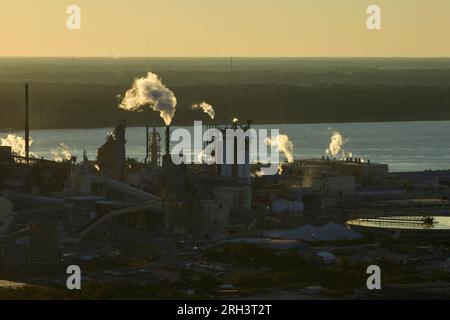 Huge factory with high chimneys polluting atmosphere with carbon ...