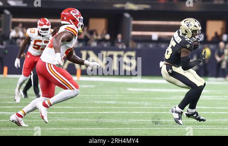 Kansas City Chiefs linebacker Cam Jones, right, signs autographs for ...
