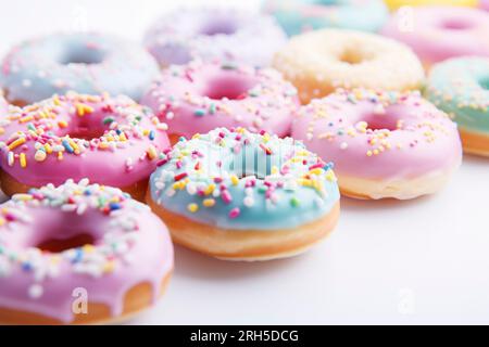 Colorful donuts showcased in a delicious array against a pristine white ...