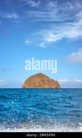 Desert volcanic island seen from the water, Galapagos National Park ...