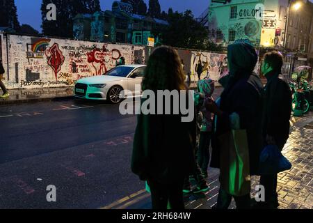 Bystanders watch Anti-Beijing counter-slogans in Brick Lane. "Brick ...