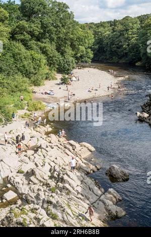 People cool off in a river as the National Weather forecaster issued an ...