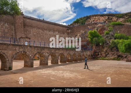 magnificent stone dam with an arched bridge during spring with blue sky ...