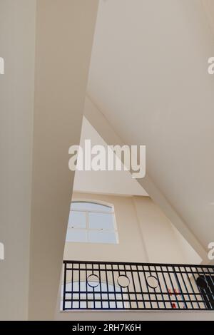 Perspective view of hallway with minimalist white interior design in ...