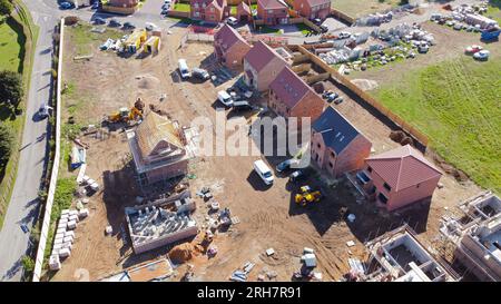 New housing estate at various stages of construction: from excavations ...