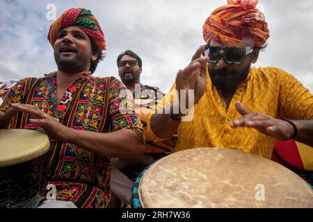 An Indian wedding or festival drummer during a band break standing ...