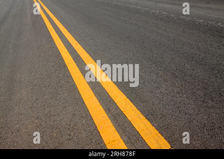 yellow double solid line on the road Stock Photo - Alamy