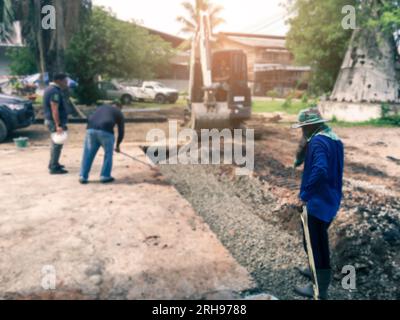 Construction worker steering a backhoe to renovate the site in ...
