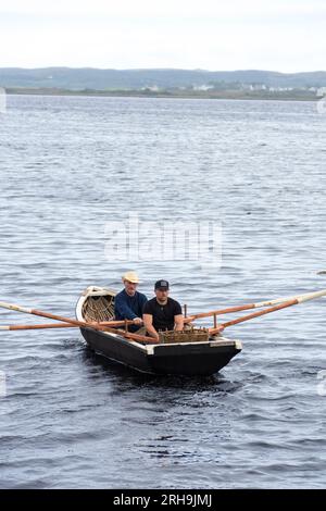 Rowing the traditional hand built currach boat, Ardara, County Donegal ...