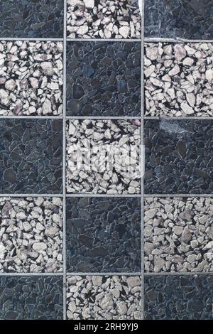 Repeating patternof square tiles with perpendicular lines and gravel ...