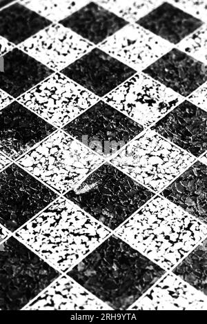 Repeating patternof square tiles with perpendicular lines and gravel ...