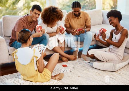 Group of friends relaxing and playing cards together. Young people ...