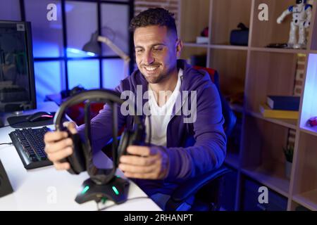 Young hispanic man streamer smiling confident using computer at gamin ...