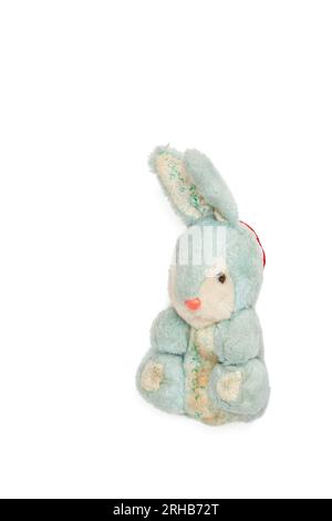 Well-loved stuffed rabbit toy from the 1980s, on a grey carpet Stock ...
