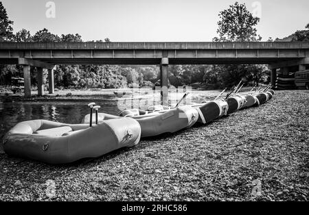 Row of inflatable rafts at the beginning of a float trip on a river ...