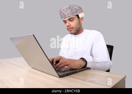 Omani Man working in office Stock Photo - Alamy