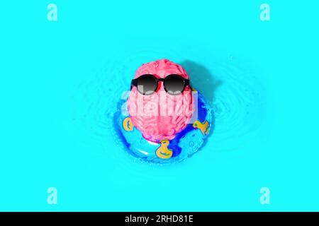 Human brain model floats on an inflatable tube in the pool. Creative ...