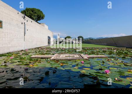 The meditation pavilion, surrounded by pools with plants and water ...