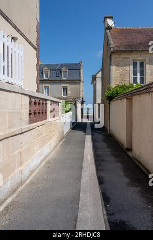 View from a tiny street of the beach, the sea and houses Stock Photo ...