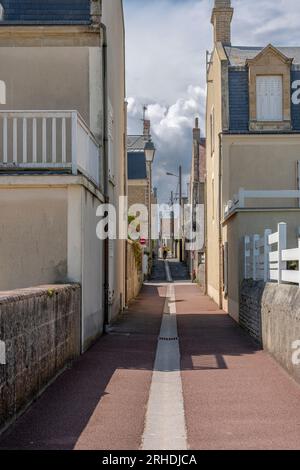 View from a tiny street of the beach, the sea and houses Stock Photo ...