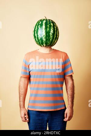 Funny man with watermelon instead of head holding corn. Conceptual ...