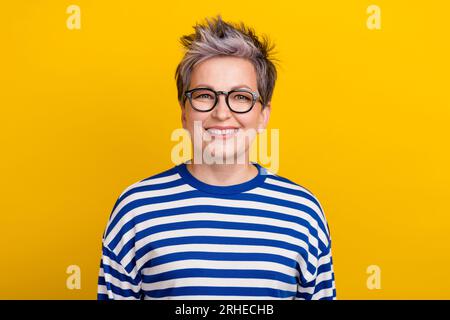 Cheerful elderly lady with short dyed hair in stylish outfit and ...